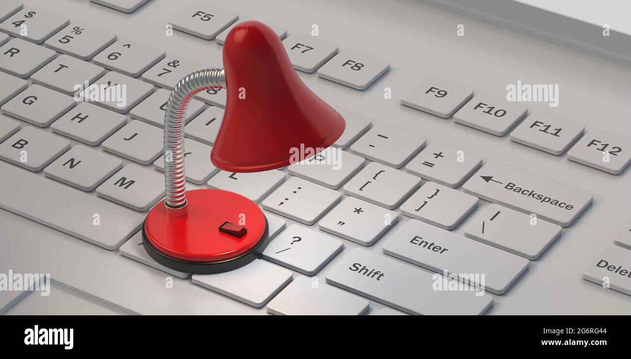 Desk lamp red color illuminated on white computer keyboard background ...