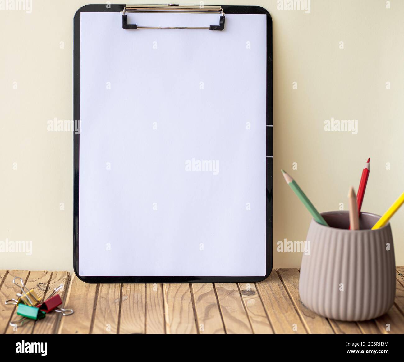 Plain Office Clipboard With Stack Of Pens In A Holder On Top Of A Table ...