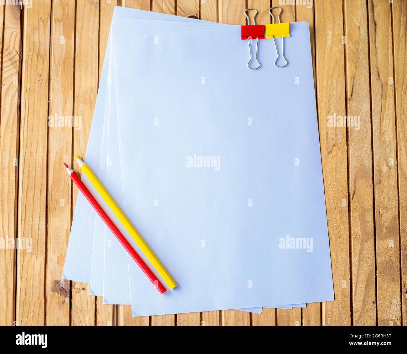 Empty Paper Clipped Together Lying Flat On A Table With Pencils And ...