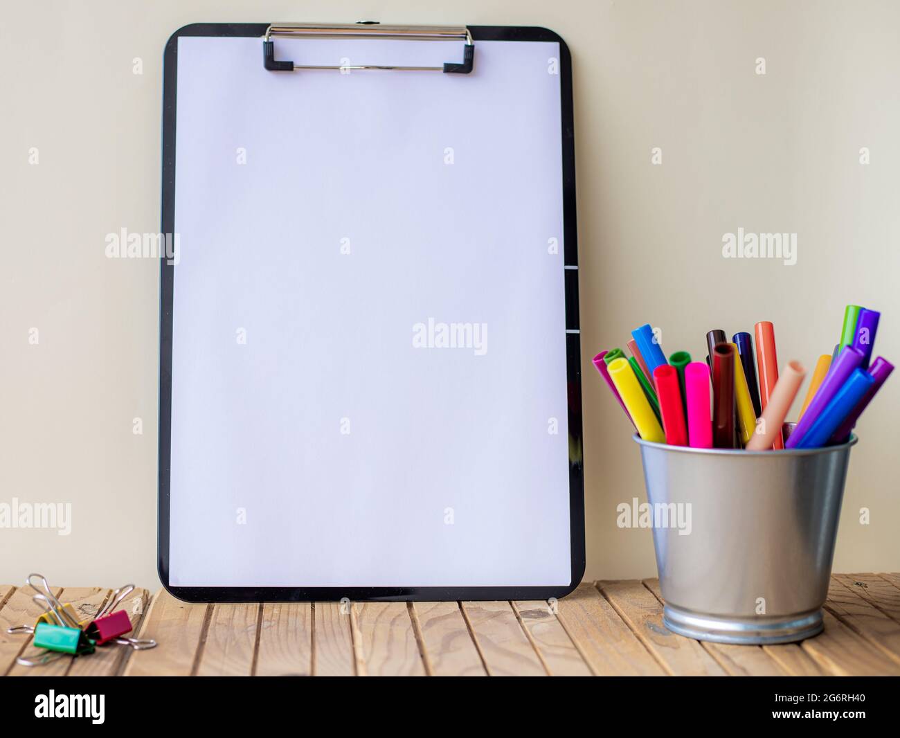 Plain Office Clipboard With Stack Of Pens In A Holder On Top Of A Table ...