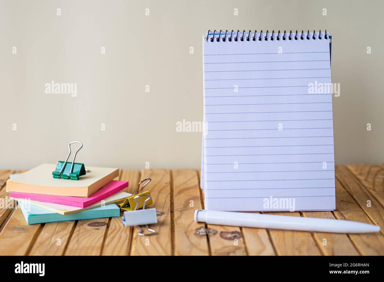 Empty Spiral Notepad With Pen Beside A Stockpile Of Sticky Notes On Top ...