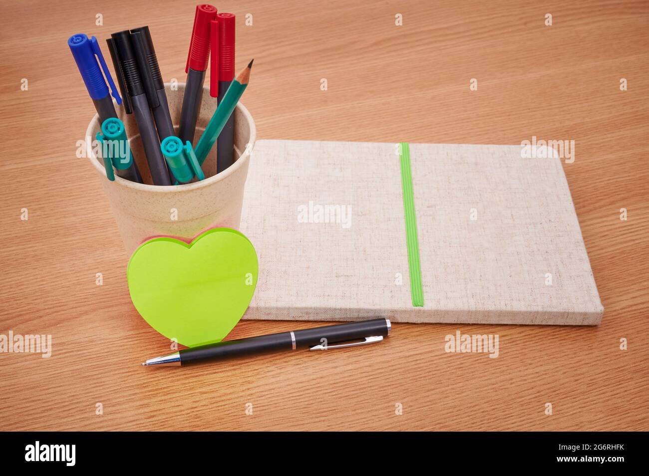 Plain Blank Open Notebooks With Stack Of Pens Inside Container Placed ...