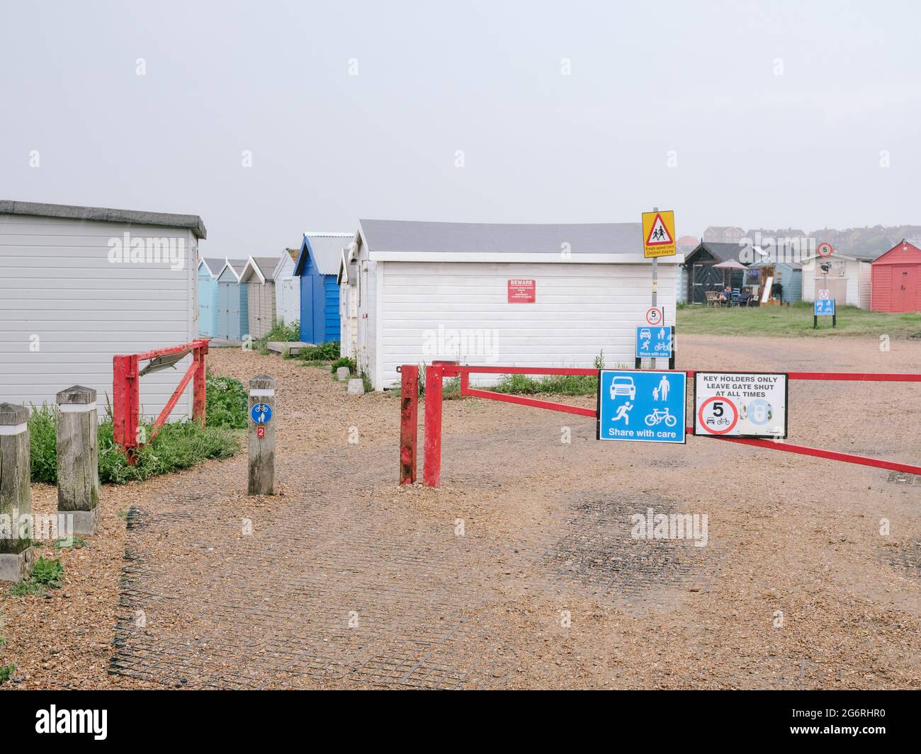 Closed painted beach huts on a grey day in the wet UK weather Stock ...