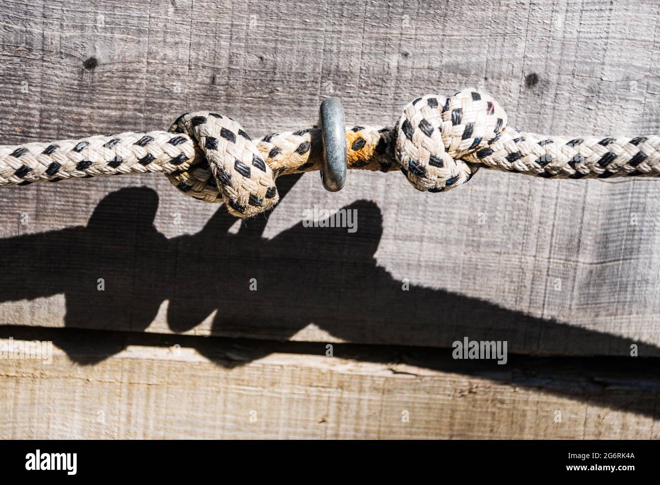 A black and white rope with two knots to serve as a railing on a steep ...