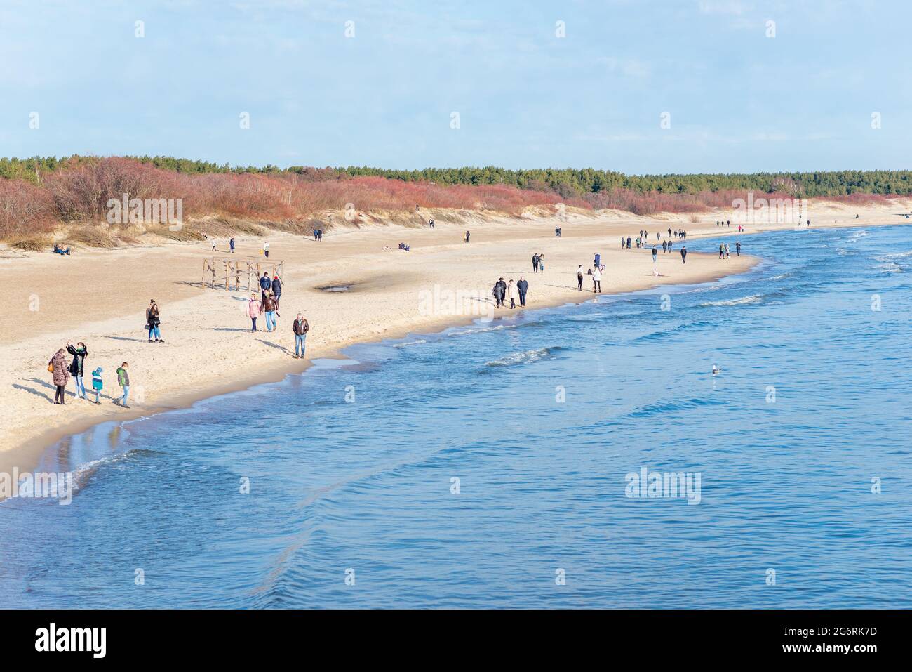 Several of people walking on the beach in spring.People walking on the ...