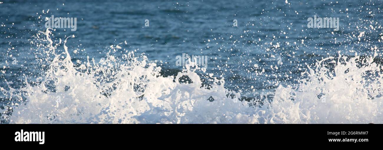 Waves splashed on a very windy day at sunset, blue sea (golden hour ...
