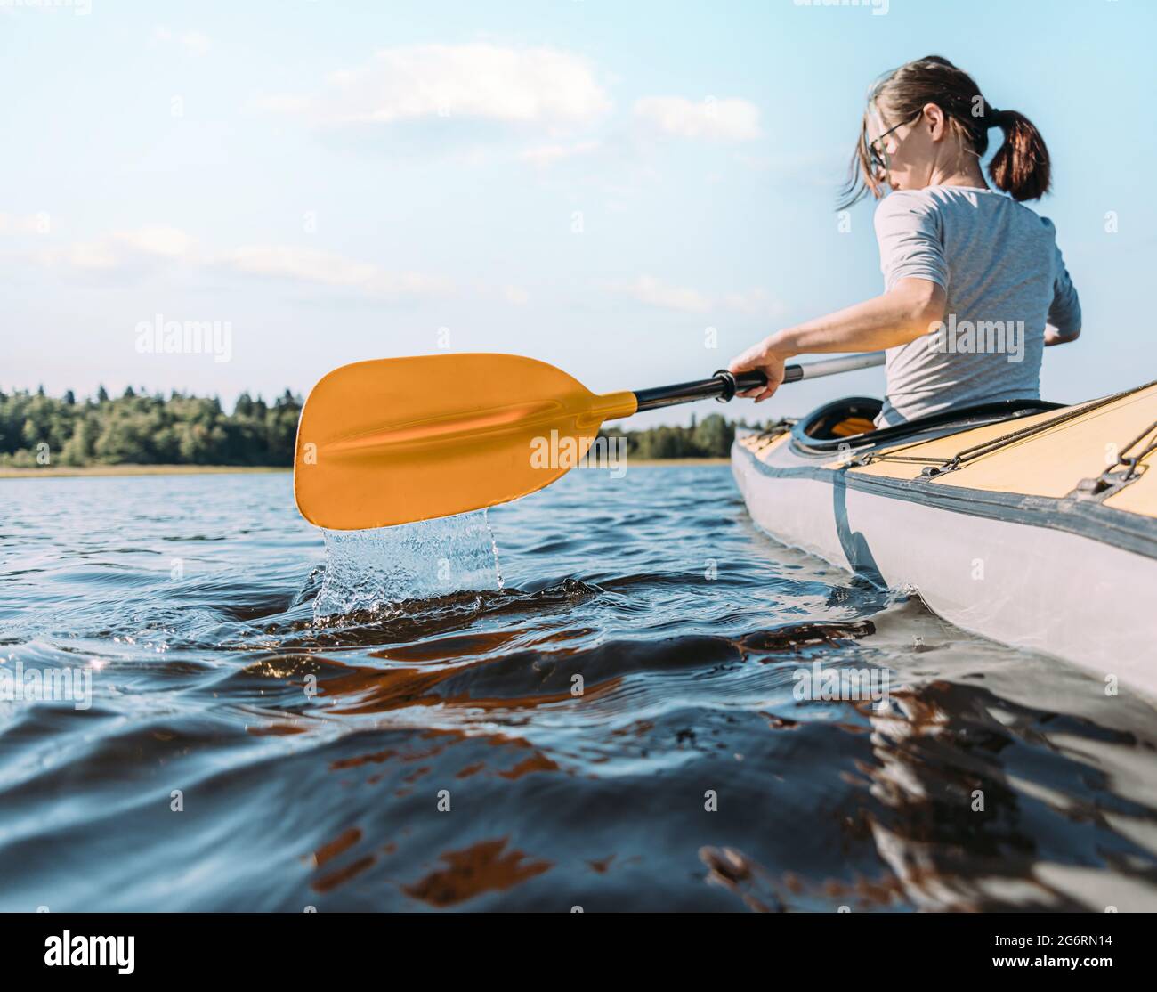 Young independent woman is sailing alone on a boat on the river Stock ...