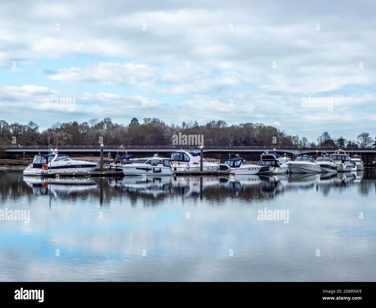 boats and clouds reflecting in the river Hamble England on a spring day ...