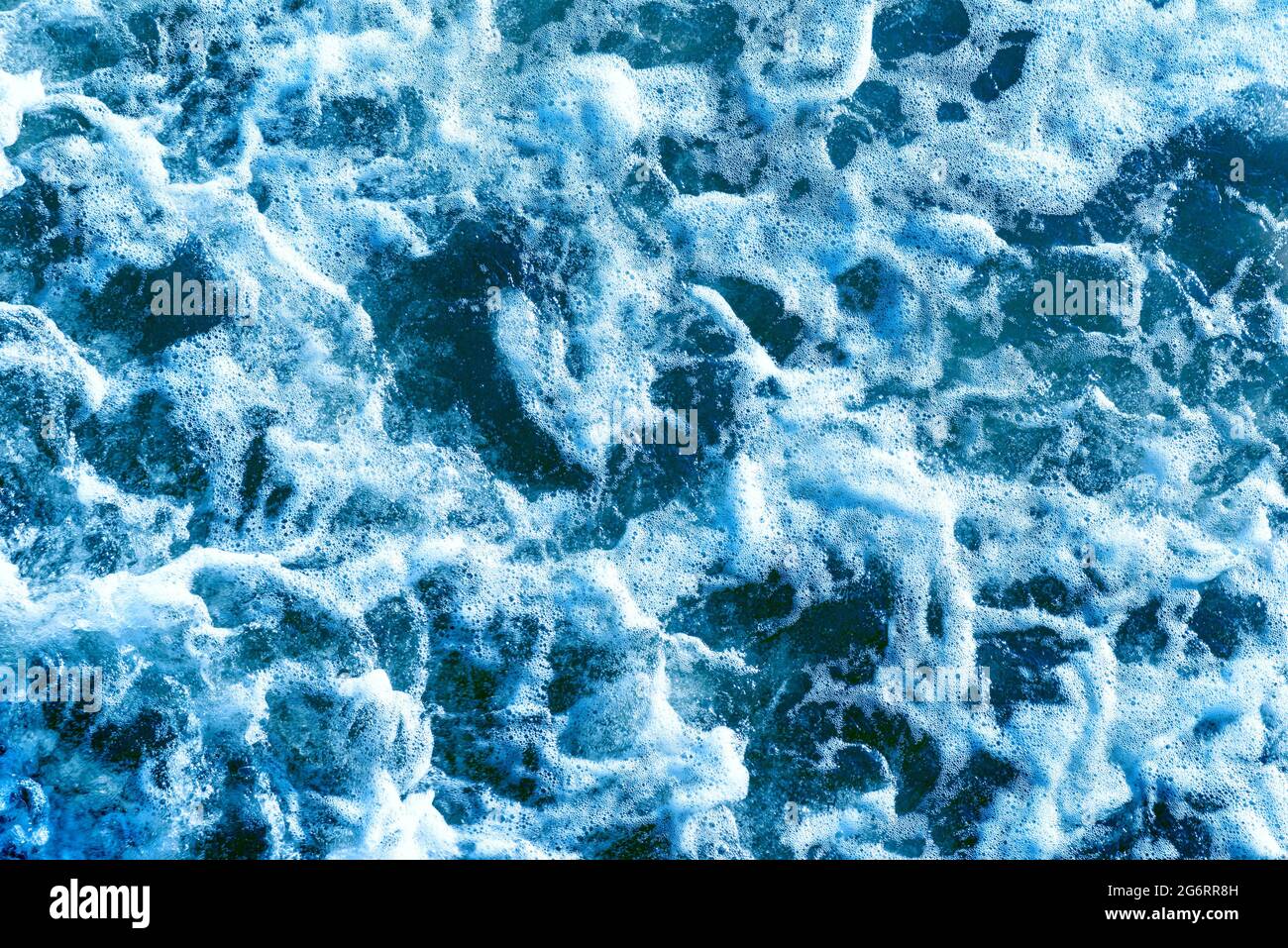 Areal shot of deep blue and rough sea with lot of sea spray.Blue ...
