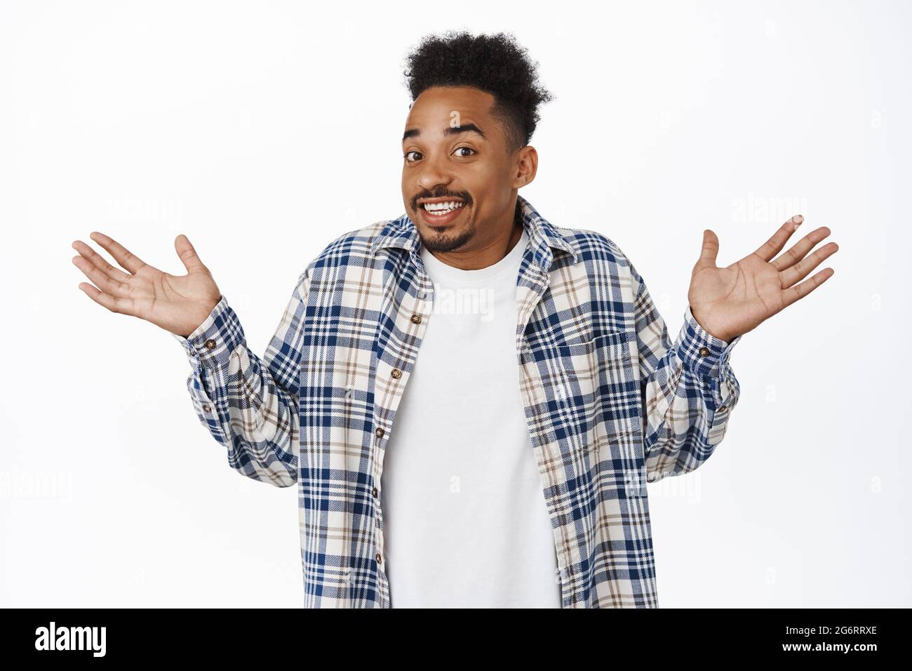 Oops sorry. Awkward african american guy, young man shrugging shoulders ...