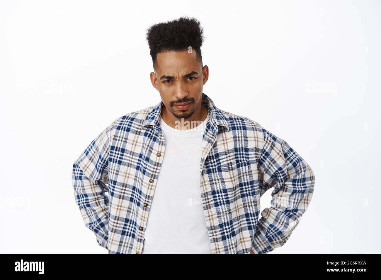 Suspicious african american guy squinting in disbelief, holding hands ...