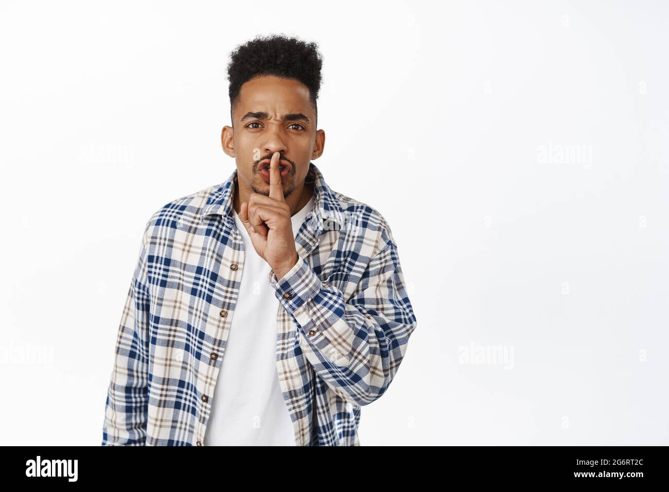 Shh be quiet. Young serious african american man hushing, press finger ...