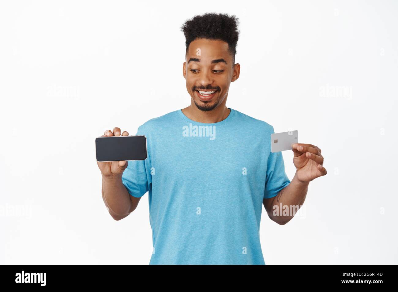 Happy african american man showing horizontal smartphone screen, credit ...