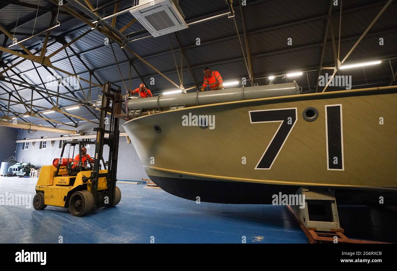 A torpedo tube is lifted onto the historic Second World War Motor ...