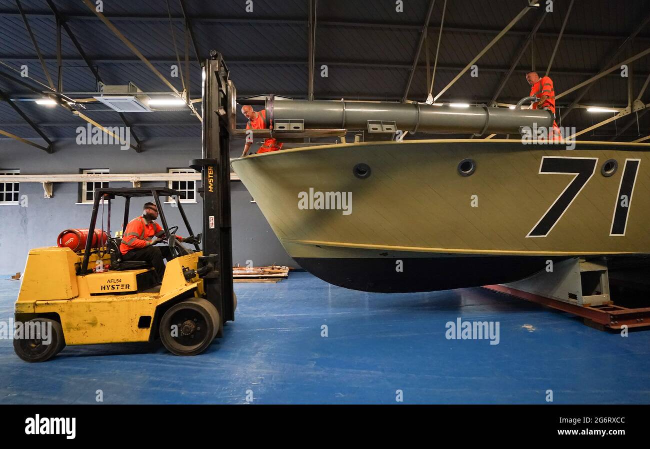 A torpedo tube is lifted onto the historic Second World War Motor ...