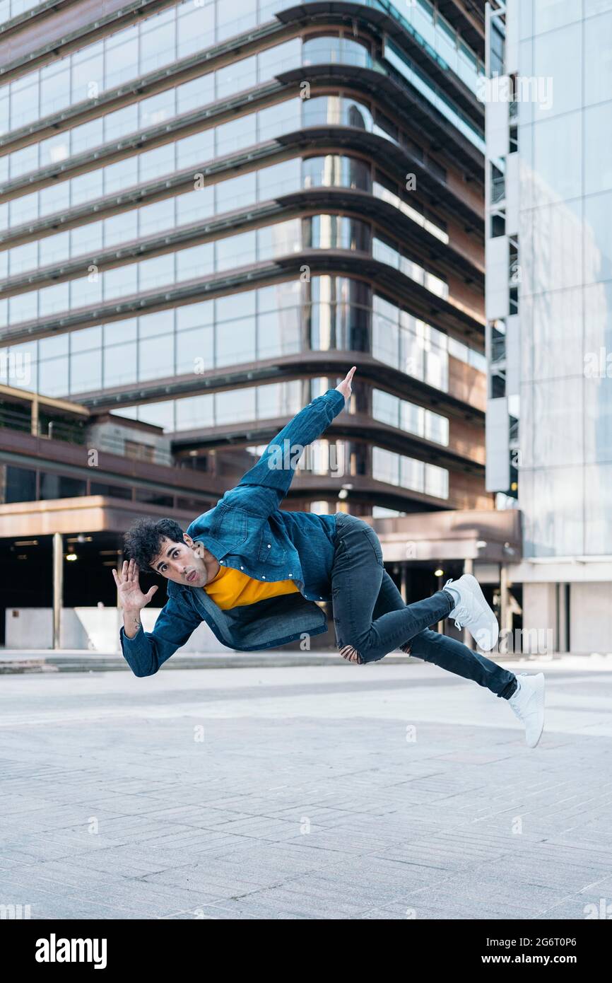Cool break dancer practicing in the street and having fun. He is ...