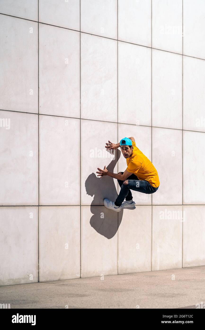 Man in front of white wall dancing hi-res stock photography and images ...
