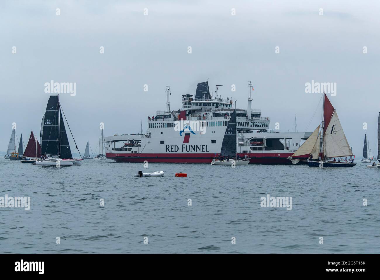 Sailing boats with the Red Funnel Isle of Wight Ferry Stock Photo - Alamy