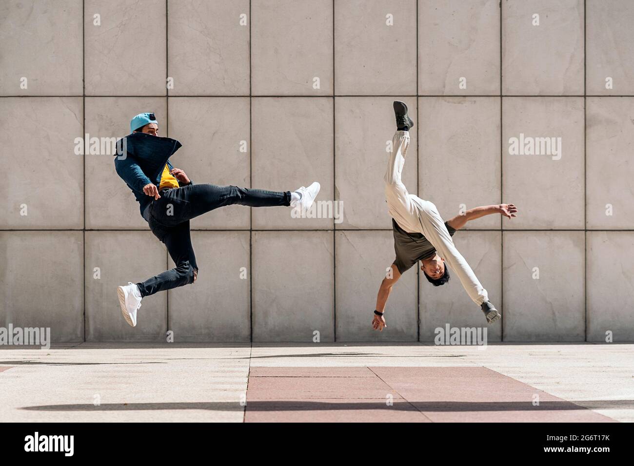 Amazing young men dancing break dance together in the city and having ...