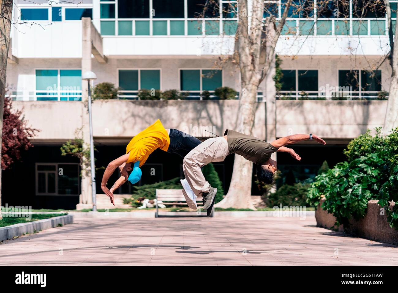 Two multi-ethnic friends dancing in the park and doing coordinated ...