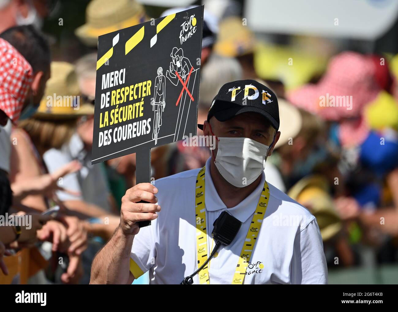 A TDF worker pictured with a sign instructing fans at stage 12 of the ...