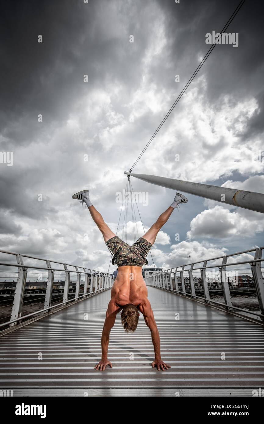 Man Doing Calisthenics Outdoors. Guy working out in the Street. Sport ...
