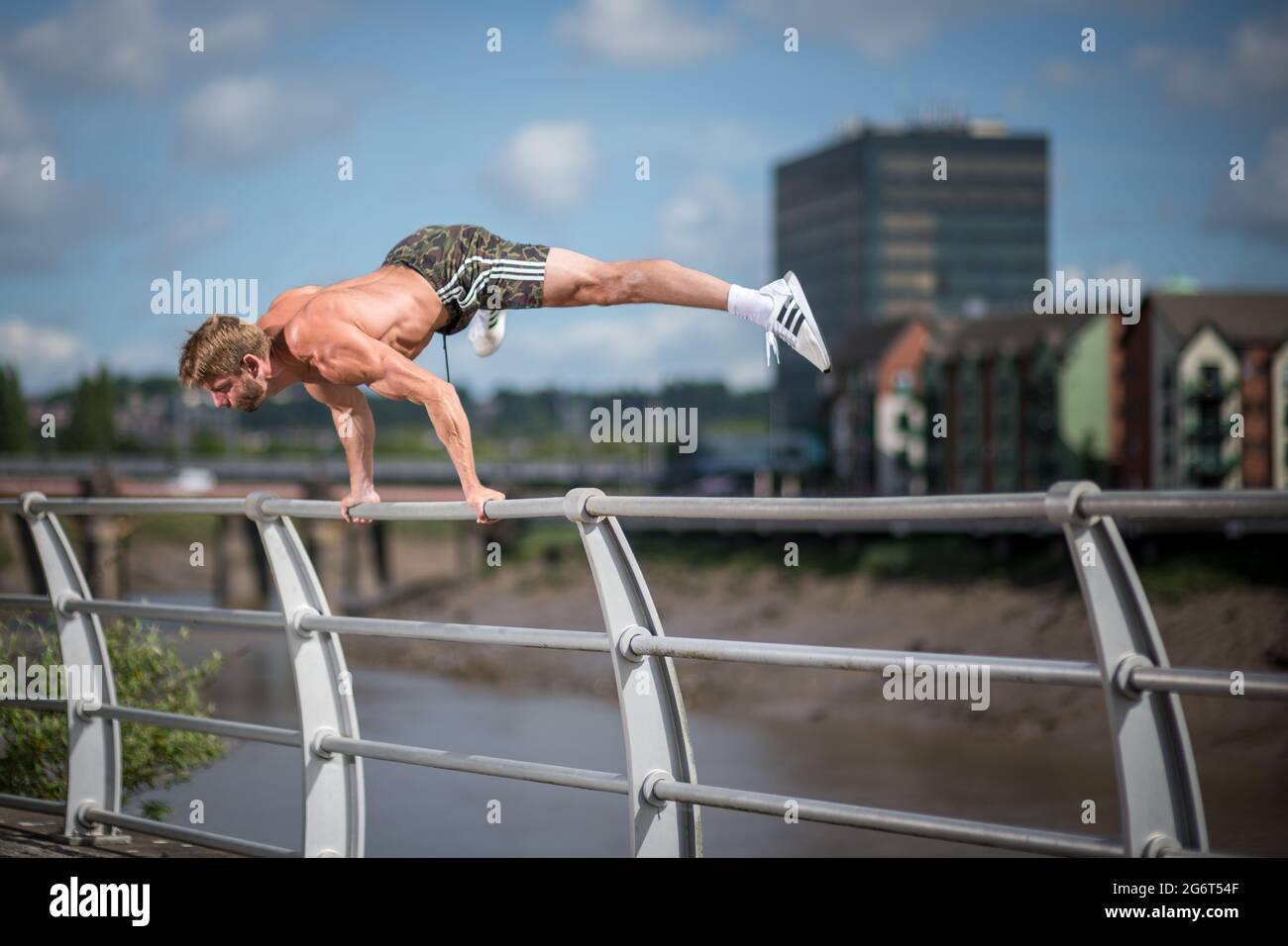 Man Doing Calisthenics Outdoors. Guy working out in the Street. Sport ...
