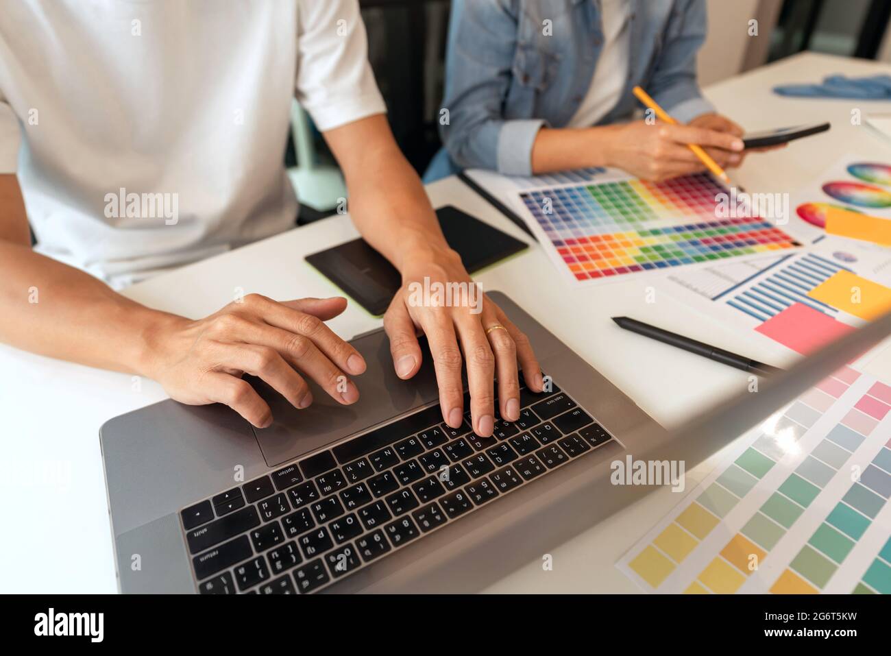 Two designers discussing color palette hi-res stock photography and ...