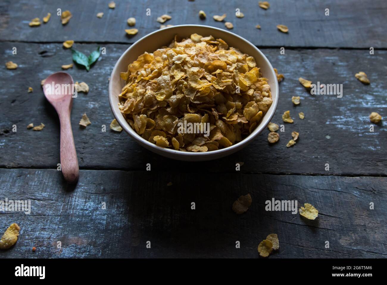 Raw cornflakes in a bowl food background. Close up Stock Photo - Alamy