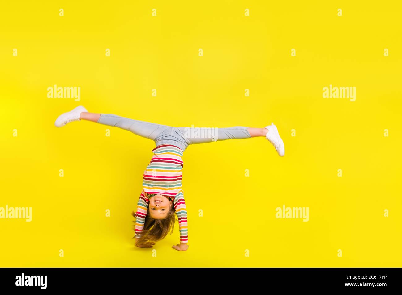 Full body photo of happy young pretty funky girl make handstand good ...