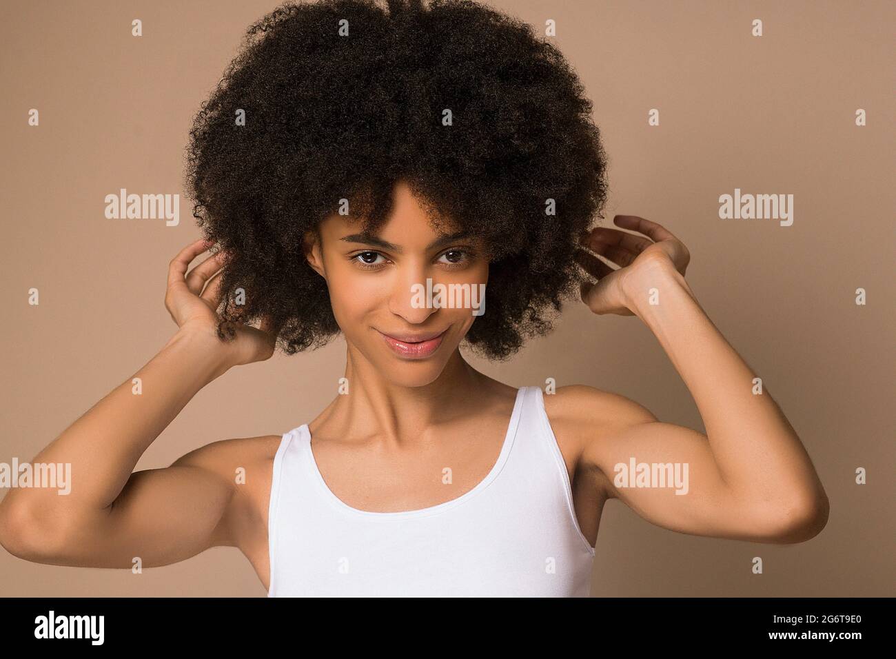 Waist up of a young pretty curly-haired mulatta Stock Photo - Alamy