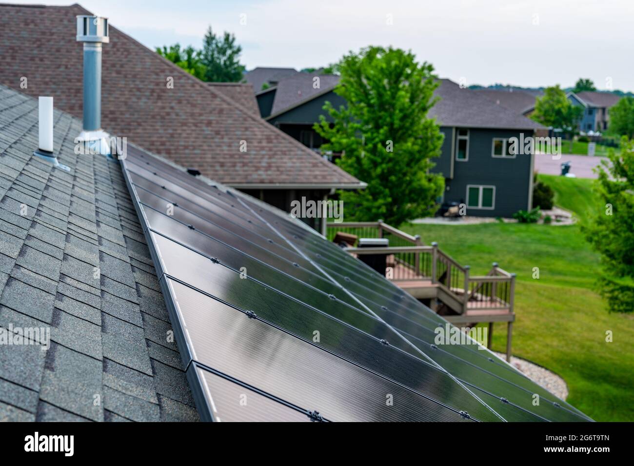 Selective focus on solar panels installed on a residential asphalt ...