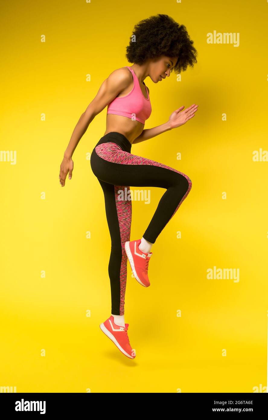 A young pretty curly-haired mulatta exercising and smiling Stock Photo ...