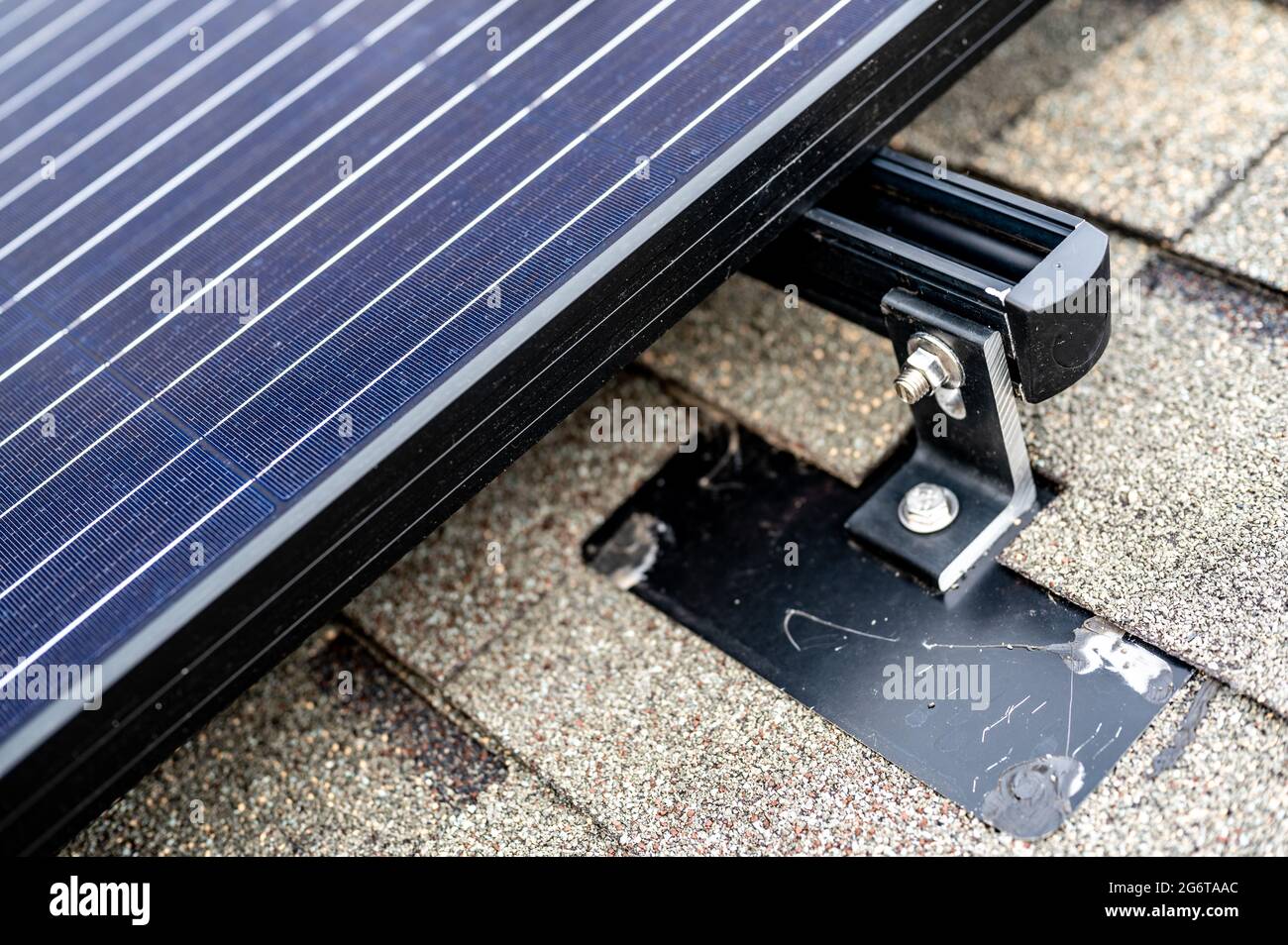 Rail, bracket, and anchor to a solar panel installed on a asphalt ...