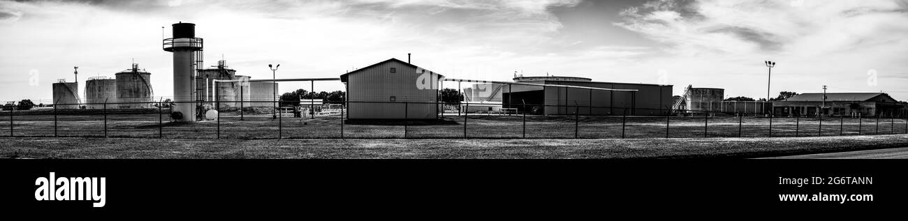 panoramic generic chemical tank farm with fencing and emergency flare ...