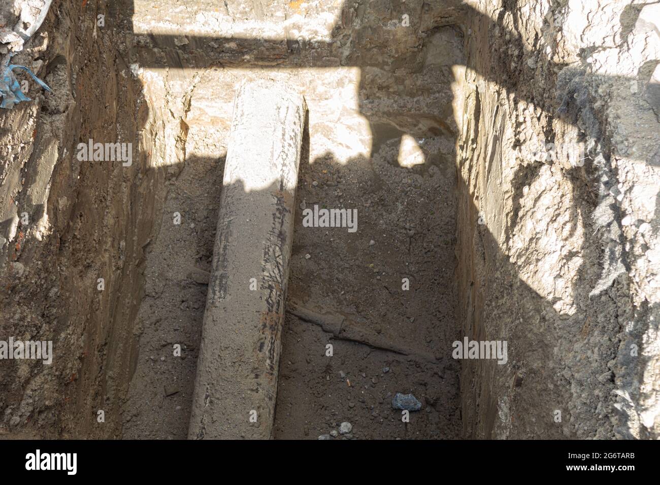Metal pipe and cable in a construction trench. Water pipe and ...