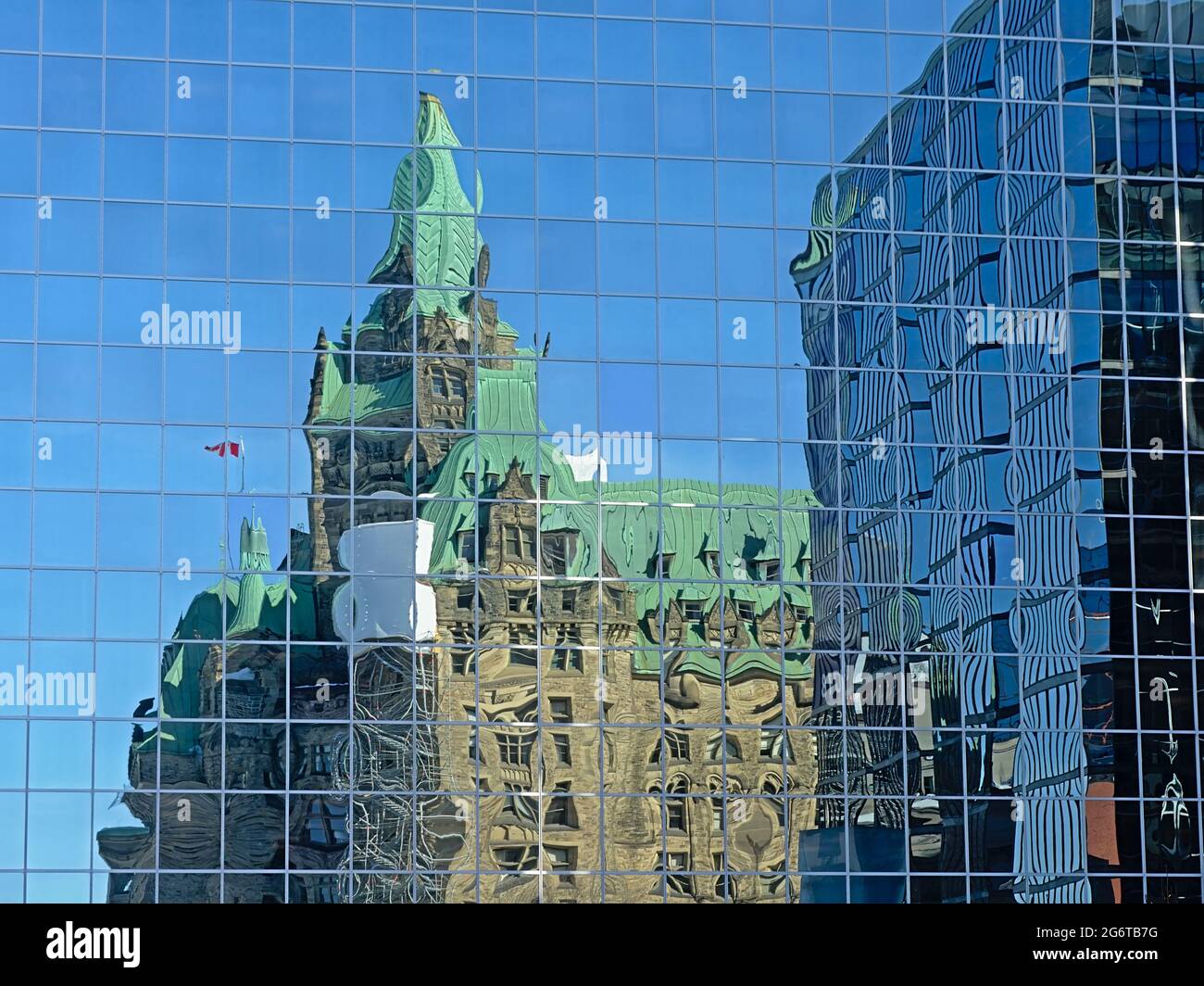 Reflection of traditional gothic revival building in the wall of a ...