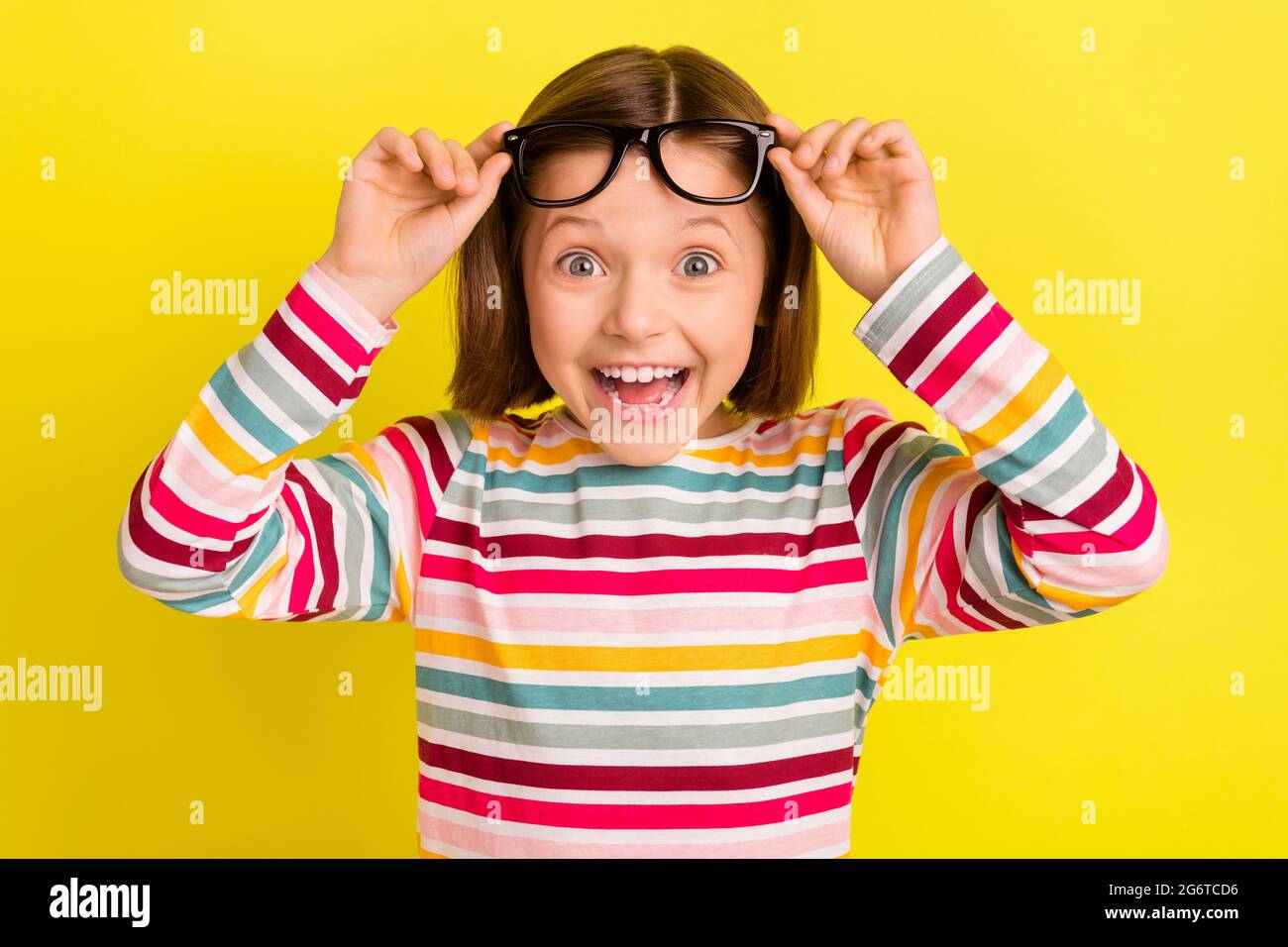 Photo portrait little girl amazed wearing spectacles striped shirt ...