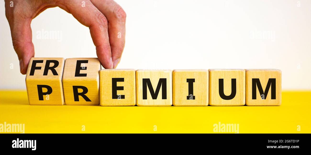 Premium or freemium symbol. Businessman turns wooden cubes and changes ...