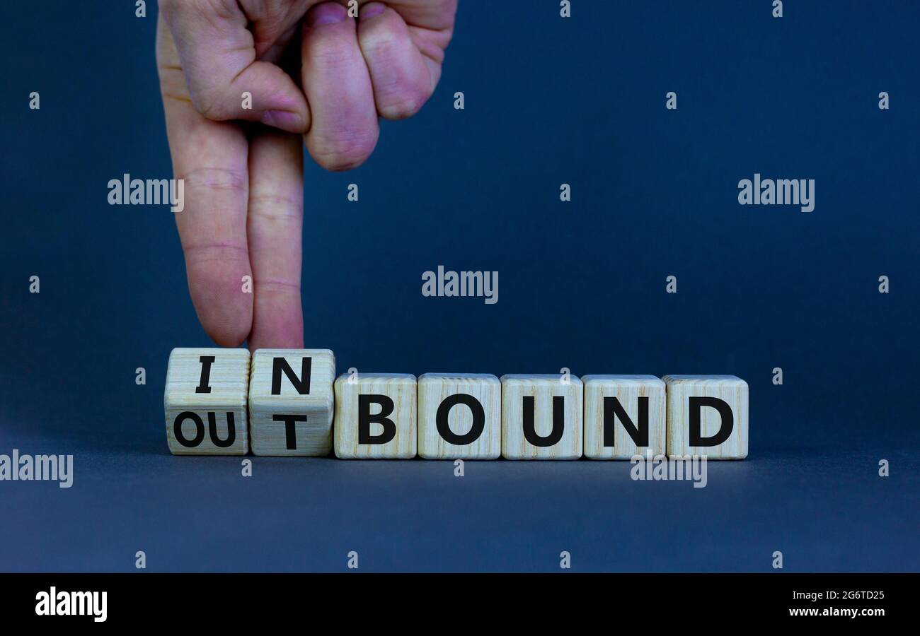 Inbound or outbound symbol. Businessman turns wooden cubes and changes ...