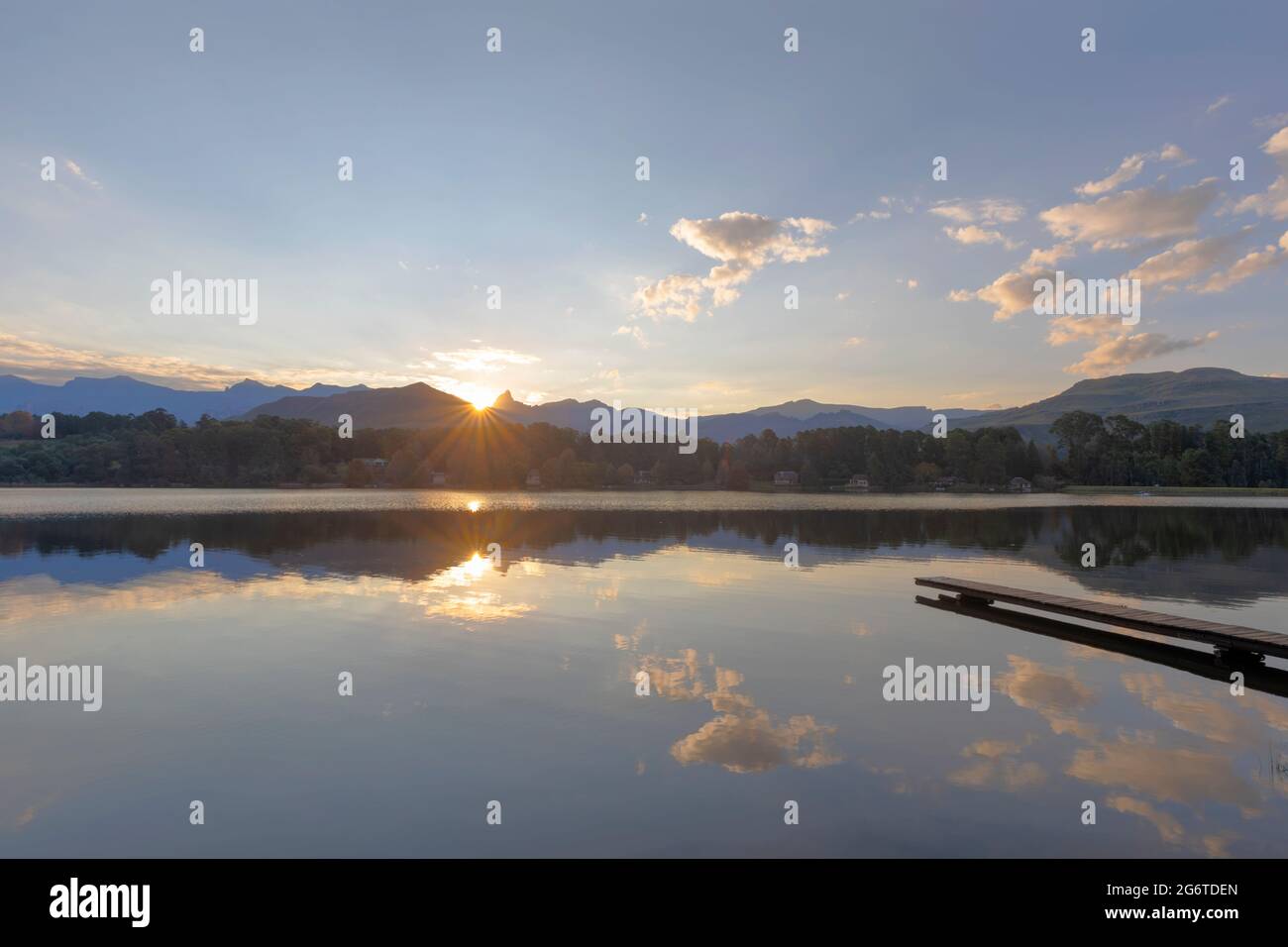 The sun set behind the mountain and reflect on the water Stock Photo ...