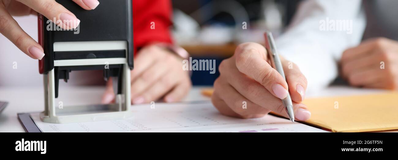 Business women signing document and certifying seal closeup Stock Photo ...