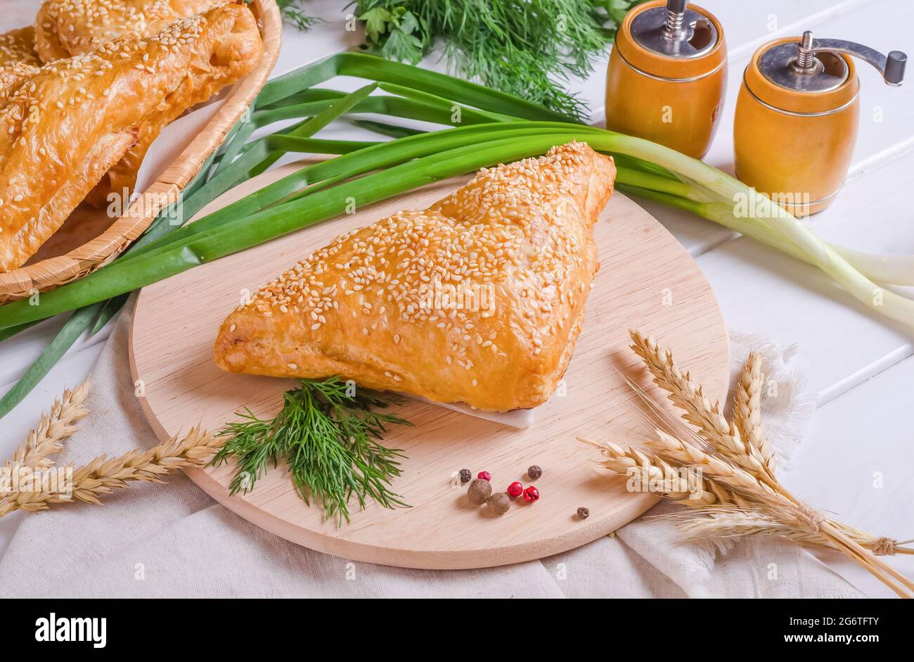 Fresh delicious triangular puff pastry bun with sesame seeds stuffed on ...