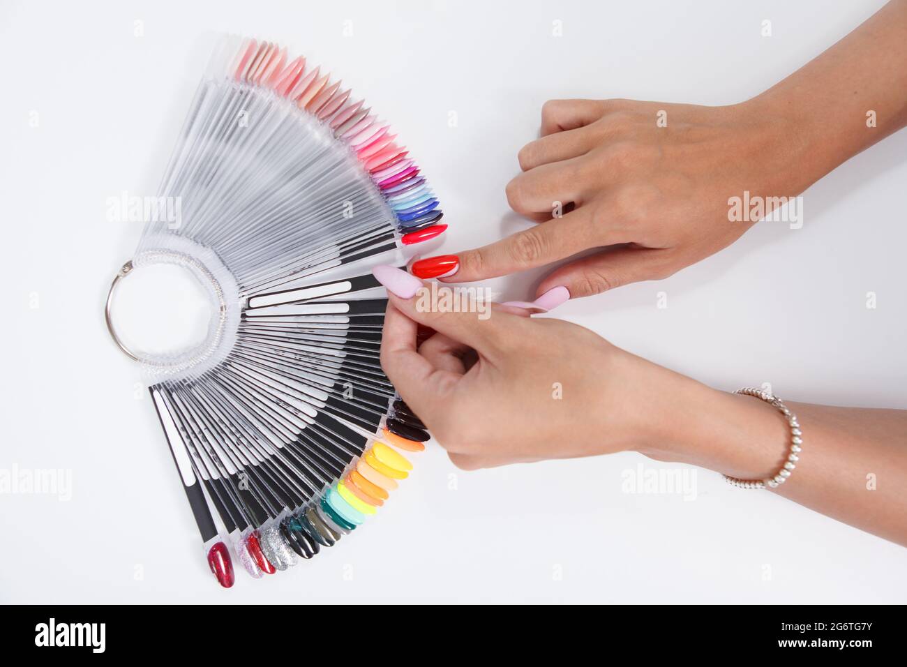 Female hands picking nail polish color from the palette Stock Photo - Alamy