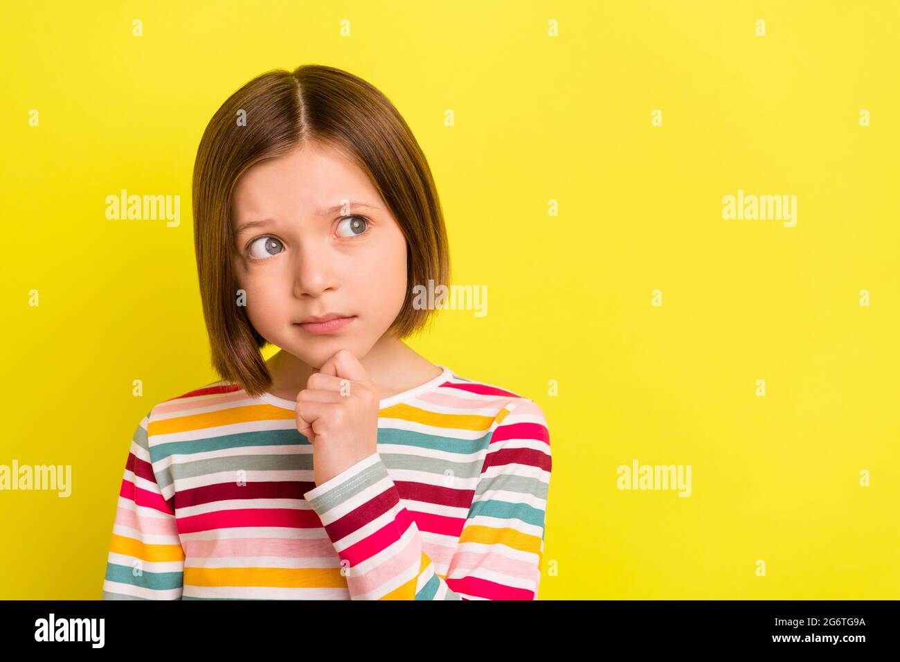 Photo of serious young minded small girl look empty space smart imagine ...