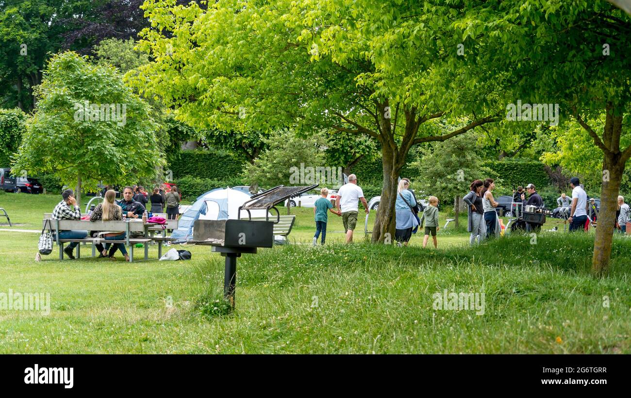 Aarhus, Denmark - 27 June 2021: People are on a picnic and walk in the ...