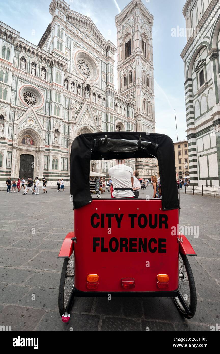 A rickshaw in Santa Maria del Fiore square. Tourists guide waiting for ...