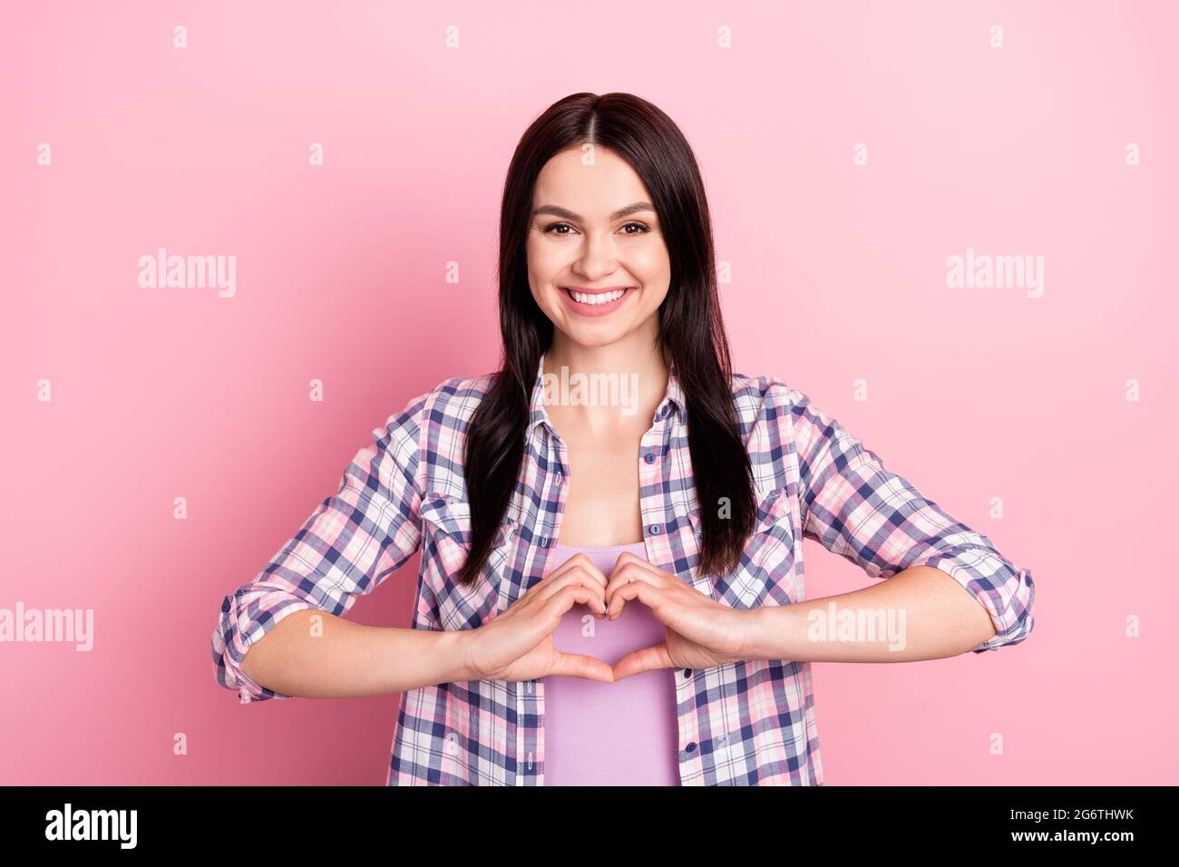 Portrait of pretty careful cheerful girl showing heart shape isolated ...