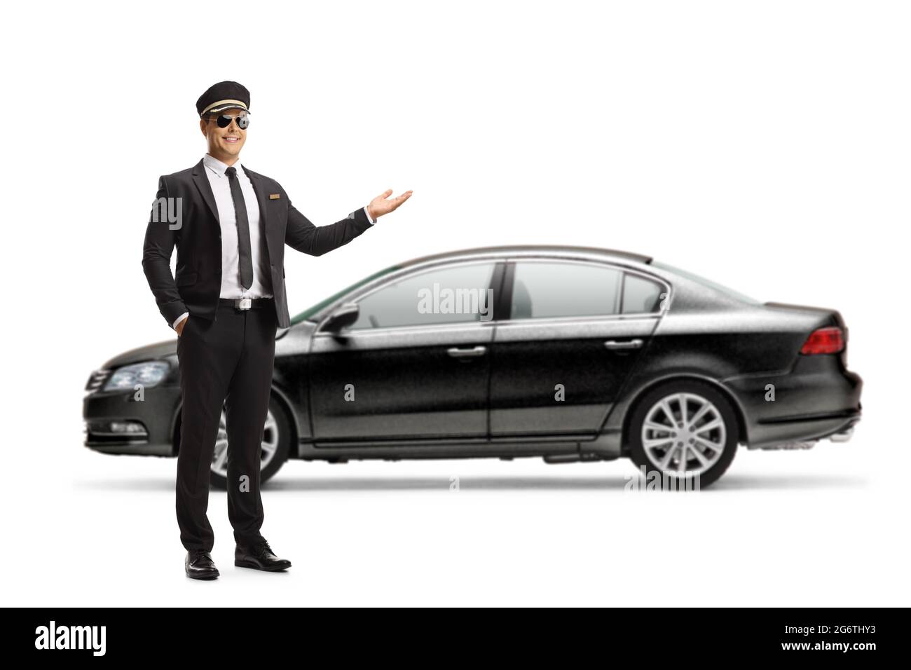 Full length portrait of a chauffeur showing a black car isolated on ...