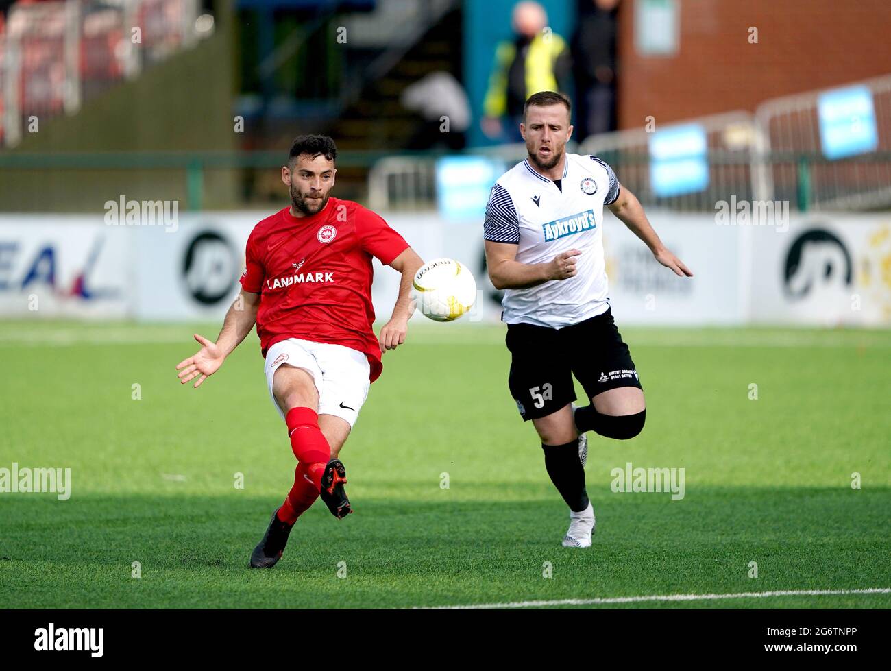 Larne's David McDaid (left) scores their side's first goal of the game ...
